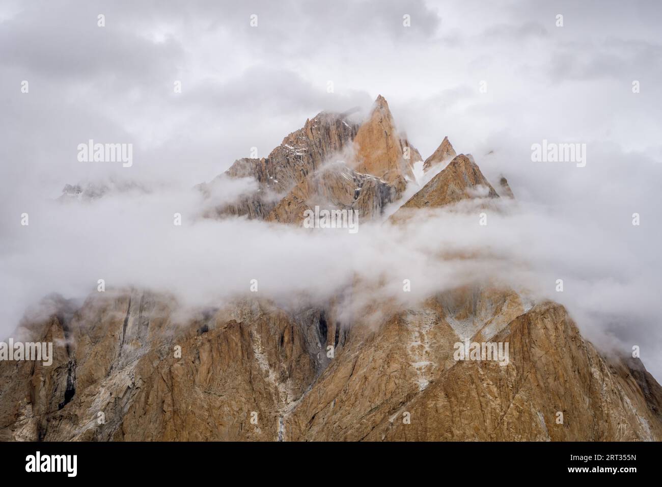 Majestic peak of Trango Towers surrounded by white clouds in Karakoram ...