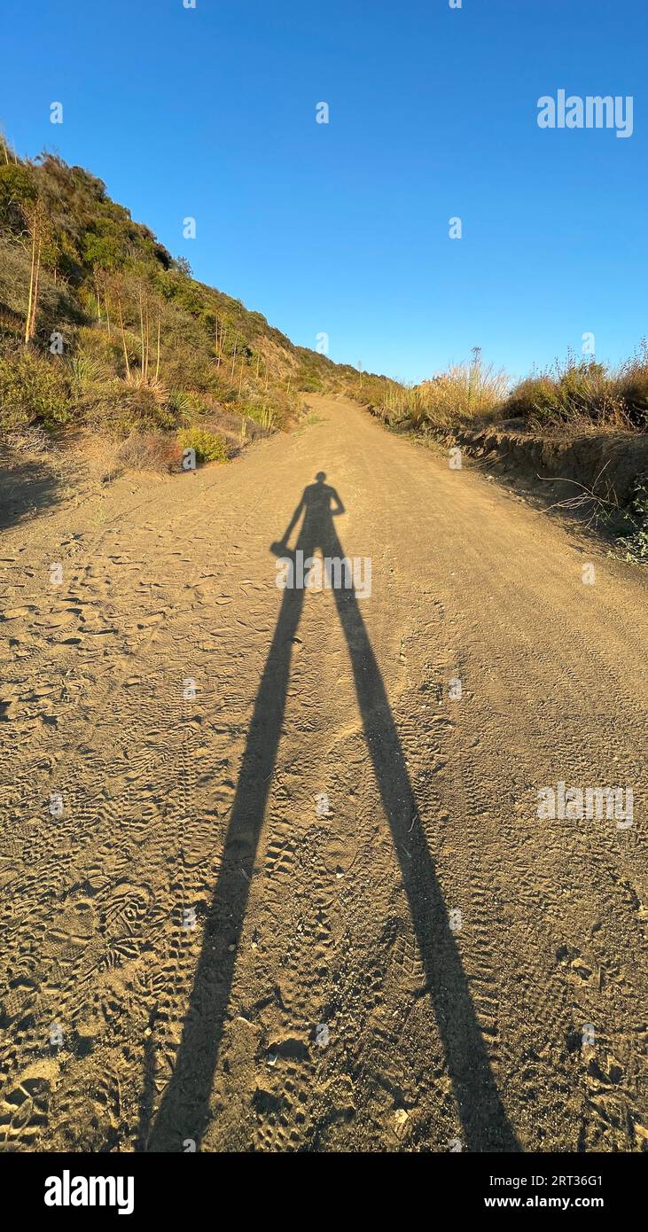 Long shadow on a dusty trail in the Santa Monica Mountains of Los ...
