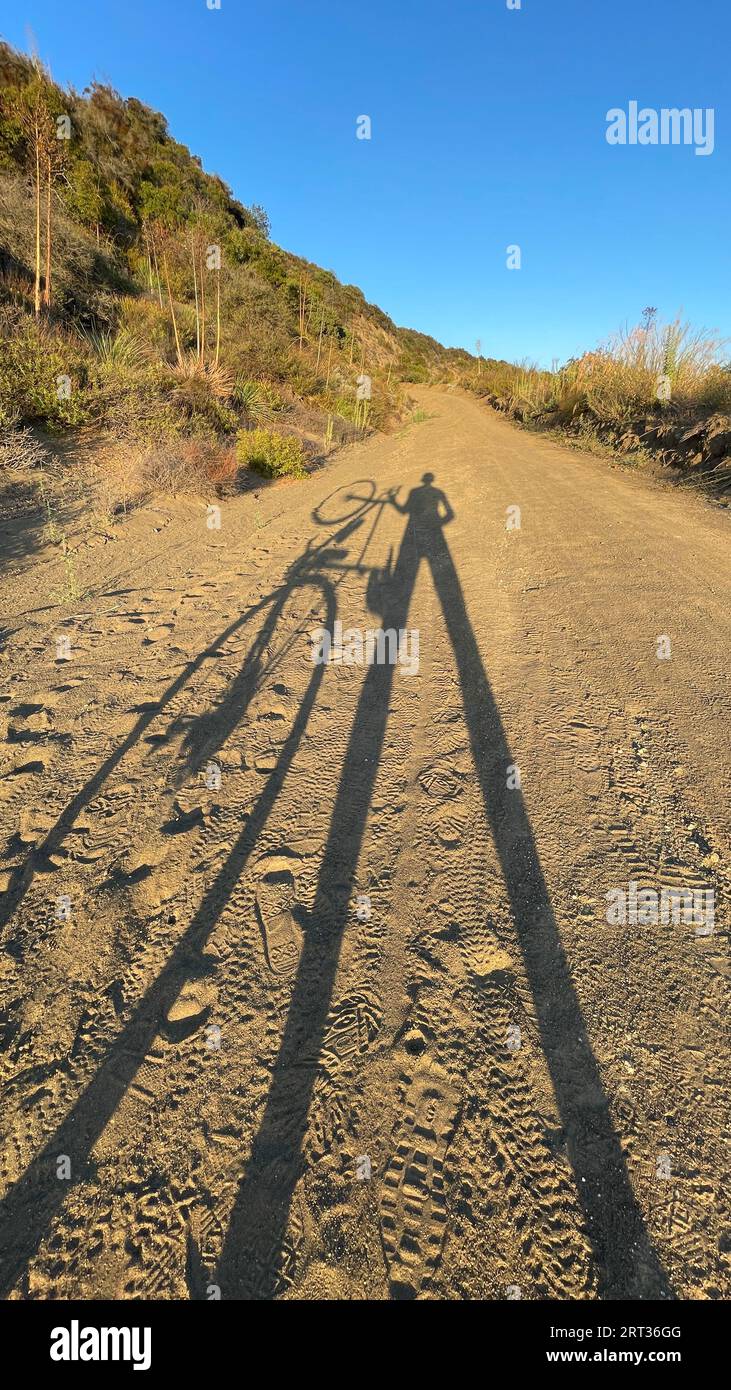 Long shadow on a dusty trail in the Santa Monica Mountains of Los ...