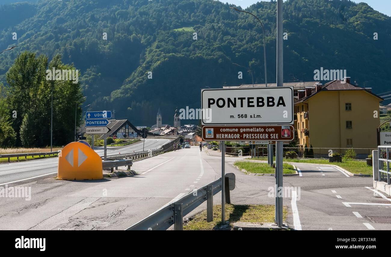 The entrance to the italian alpine town of Pontebba with its road sign ...
