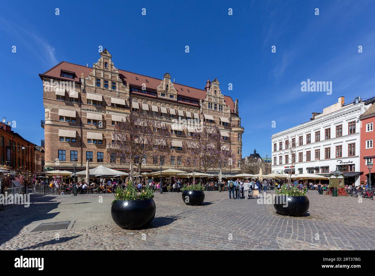 Malmo, Sweden, April 20, 2019: Historic buildings and people in cafes ...