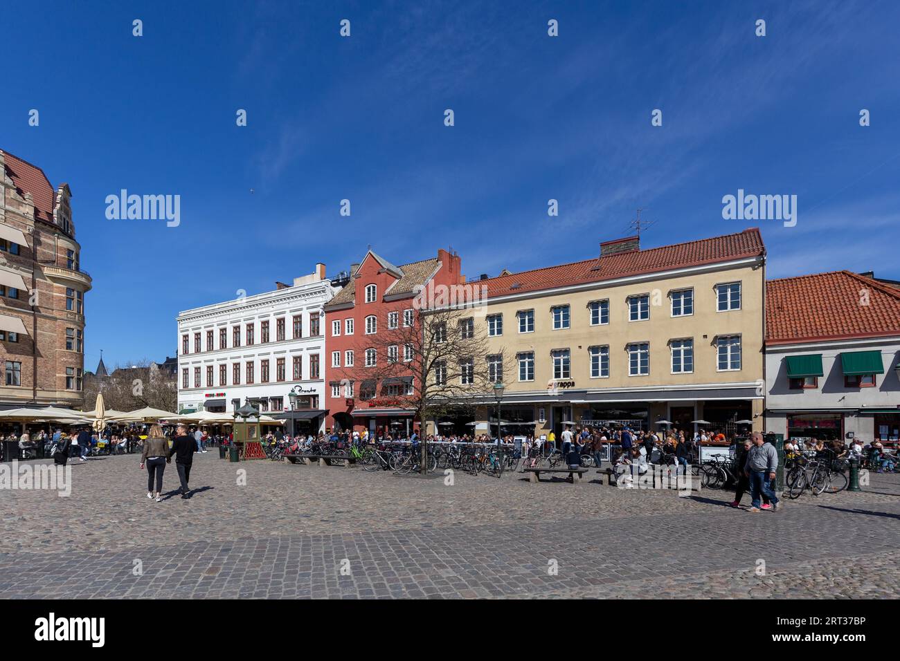 Malmo, Sweden, April 20, 2019: Historic buildings and people in cafes ...