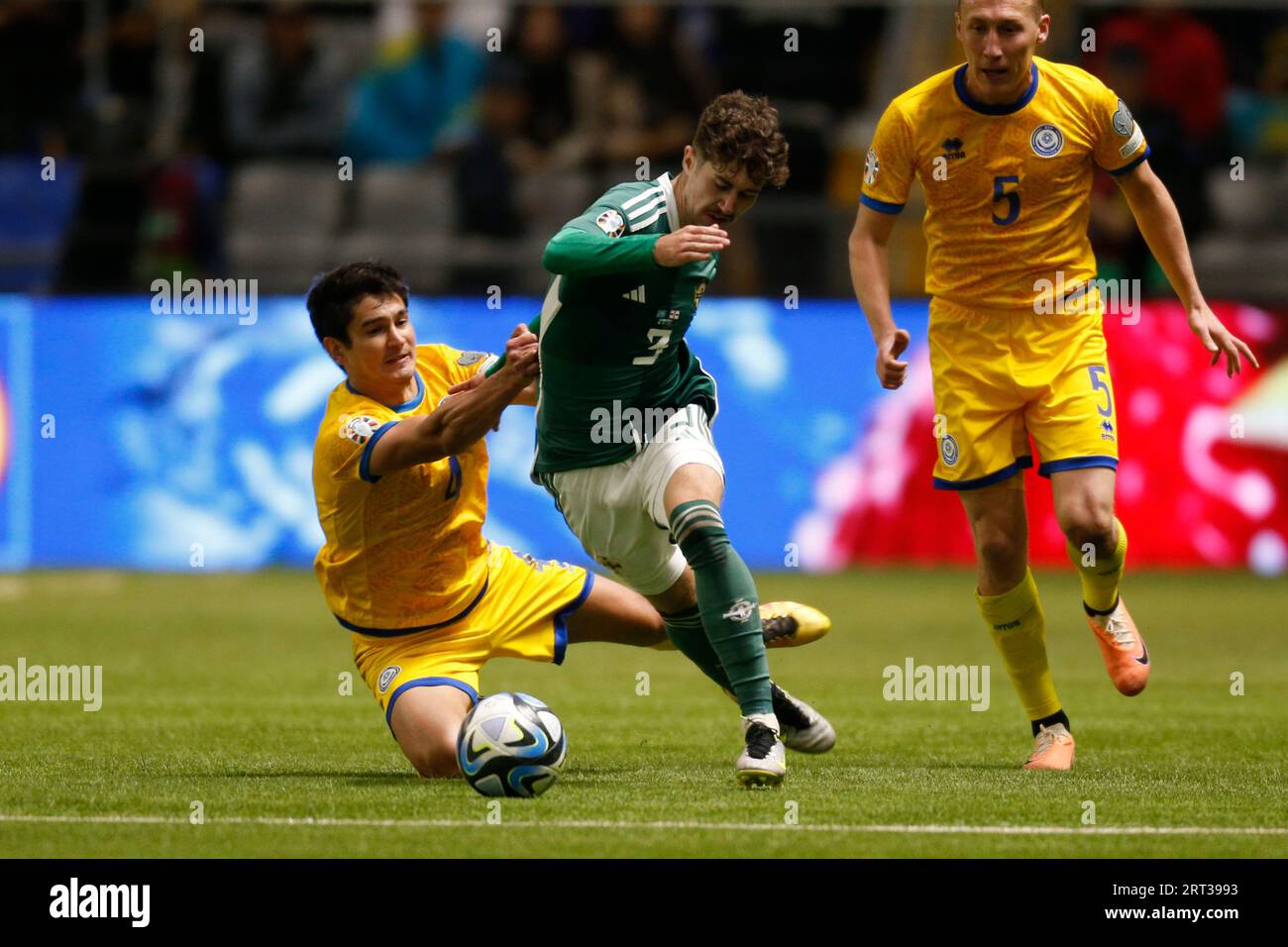Northern Ireland's Trai Hume, centre, fights for the ball with Kazakhstan's Marat Bystrov during ...