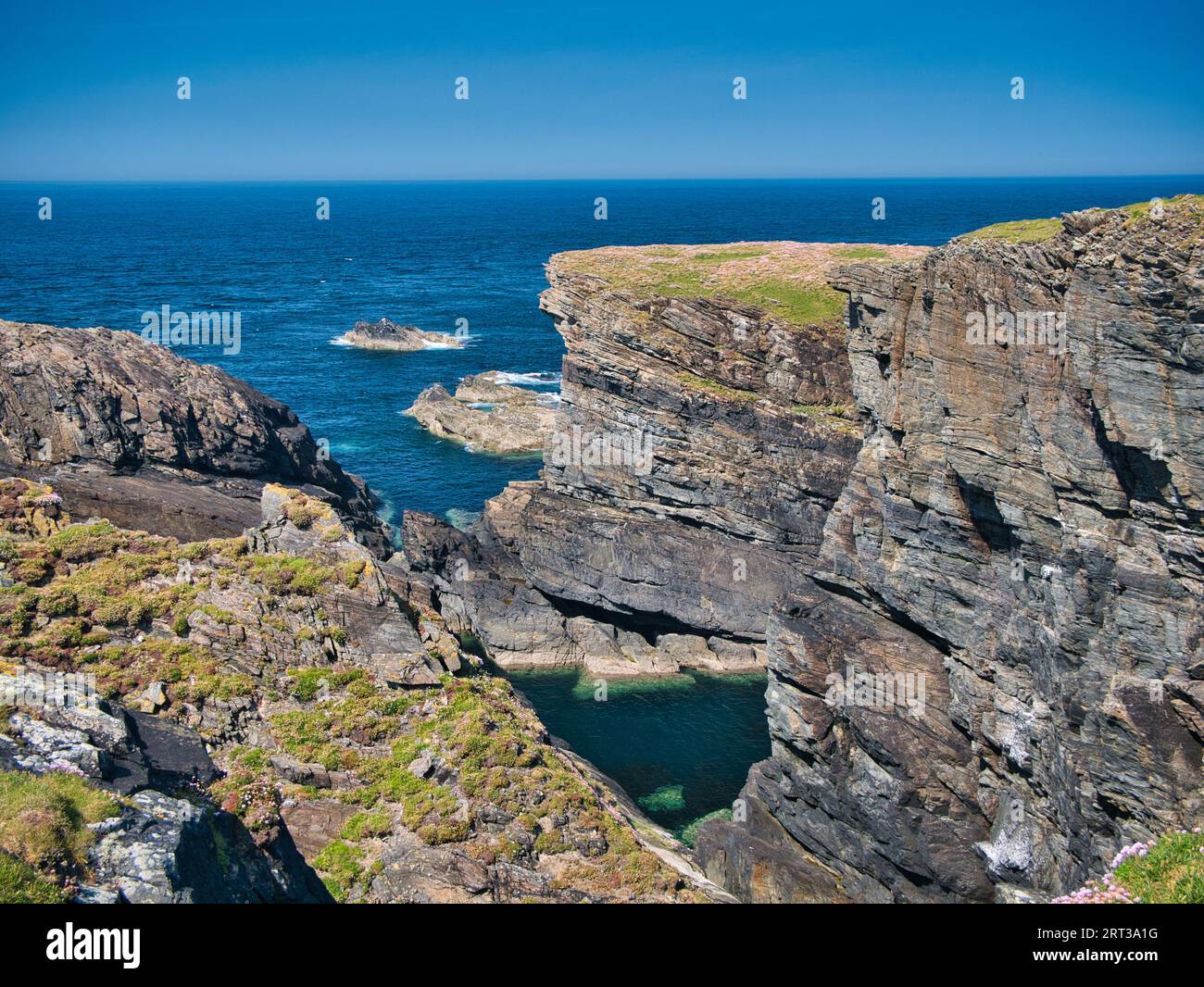Exposed rock strata in coastal cliffs on the rocky, rugged, Atlantic ...