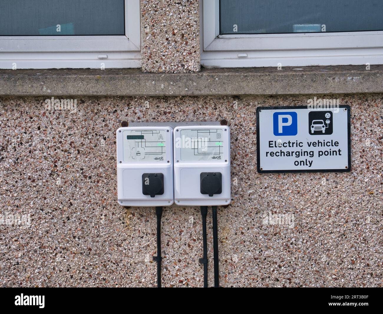 Two Evolt electric vehicle (EV) charging points with signage fixed to a ...