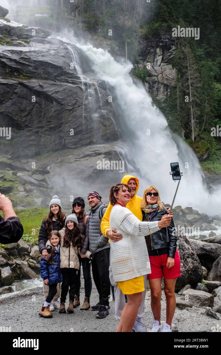 Tourists taking photographs at the Krimml Waterfalls (the highest ...