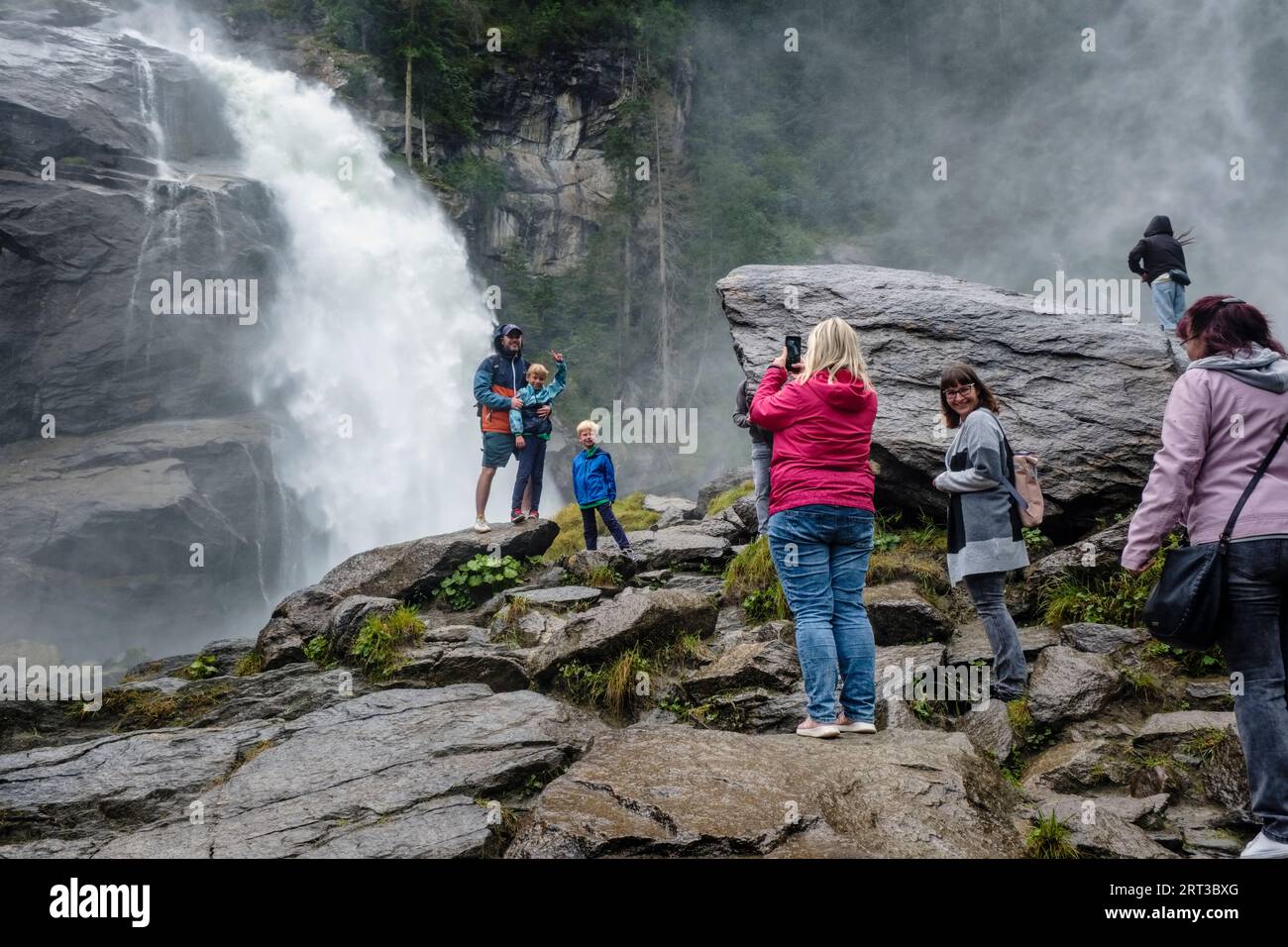 Tourists taking photographs at the Krimml Waterfalls (the highest ...