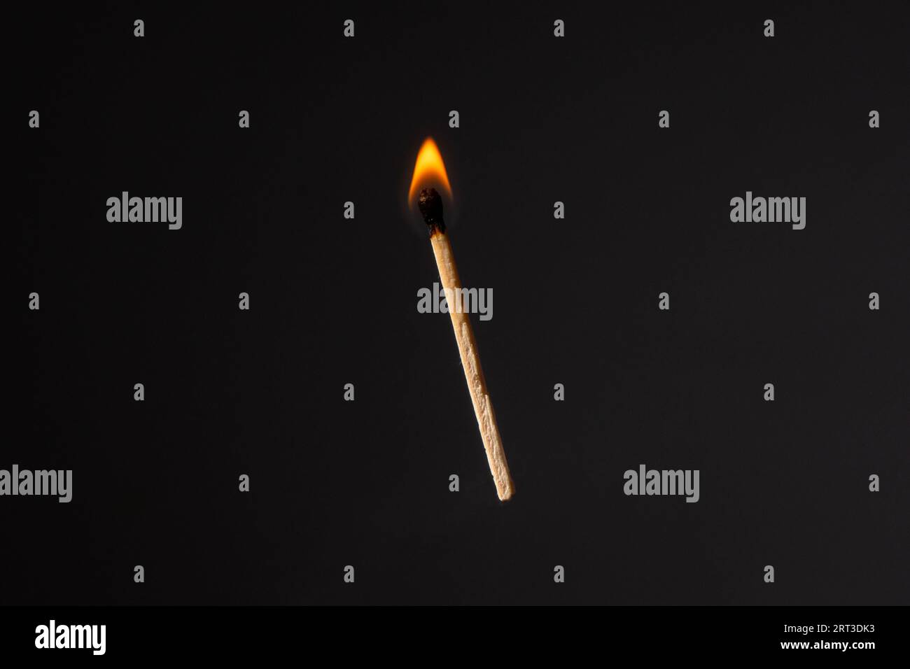 Lit and falling match on a black background Stock Photo - Alamy