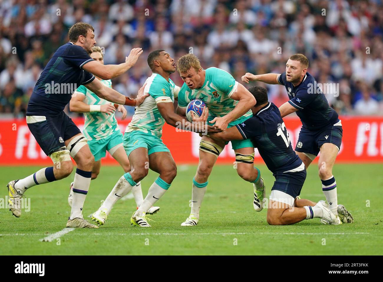 South Africa's Pieter-Steph du Toit (centre) is tackled by Scotland's ...