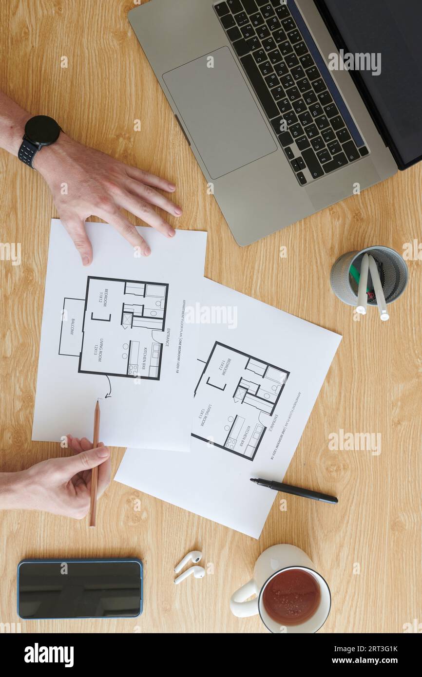 Hands of man planning house renovation, drawing on blueprint Stock ...