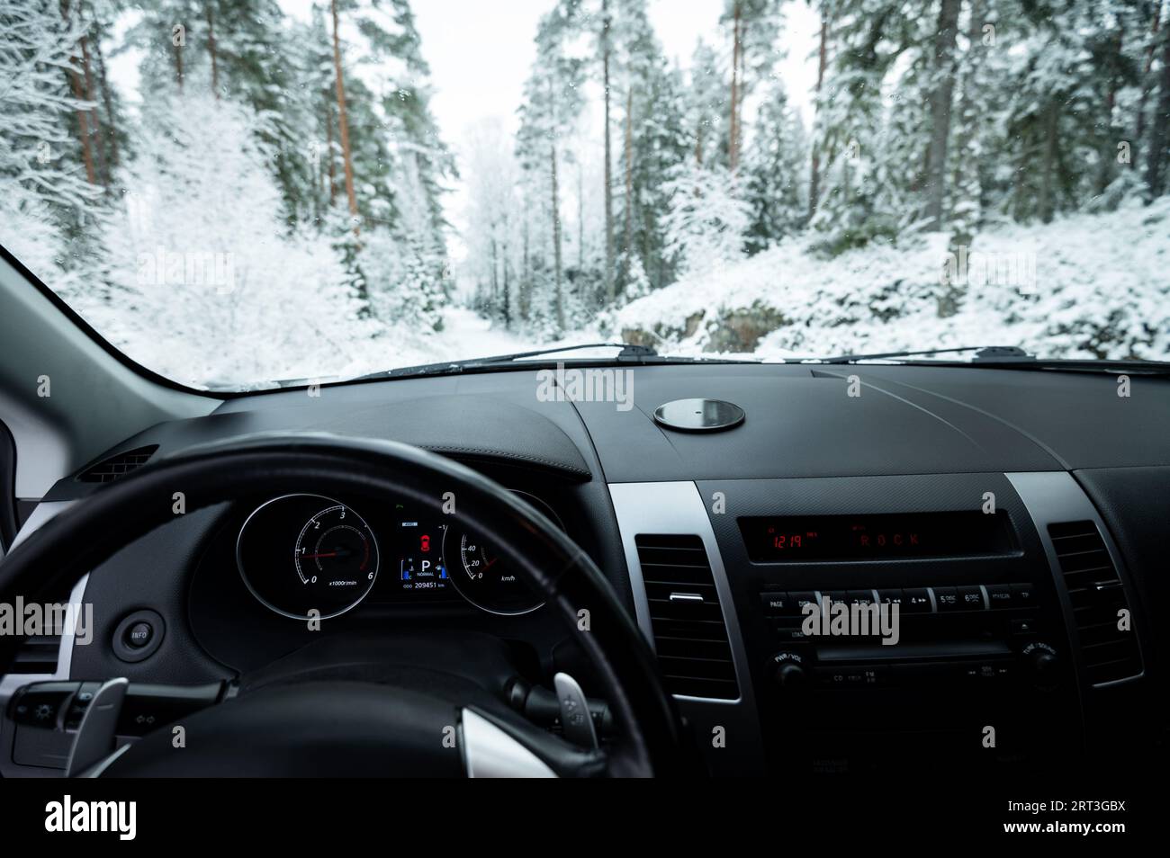 View of snowy forest with snow cowered trees seen from inside of car ...