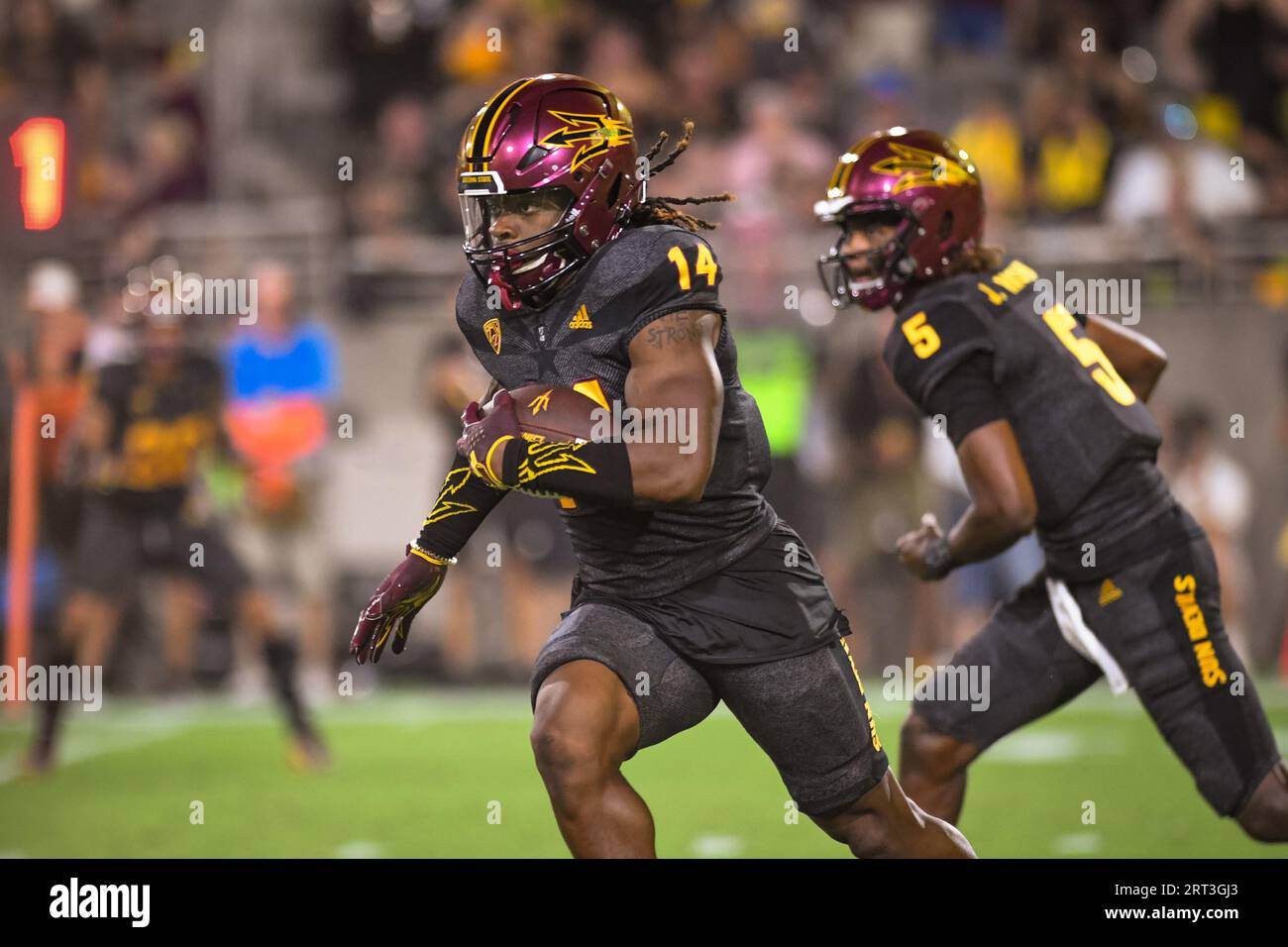 Arizona State running back Kyson Brown (14) runs for a second down in ...