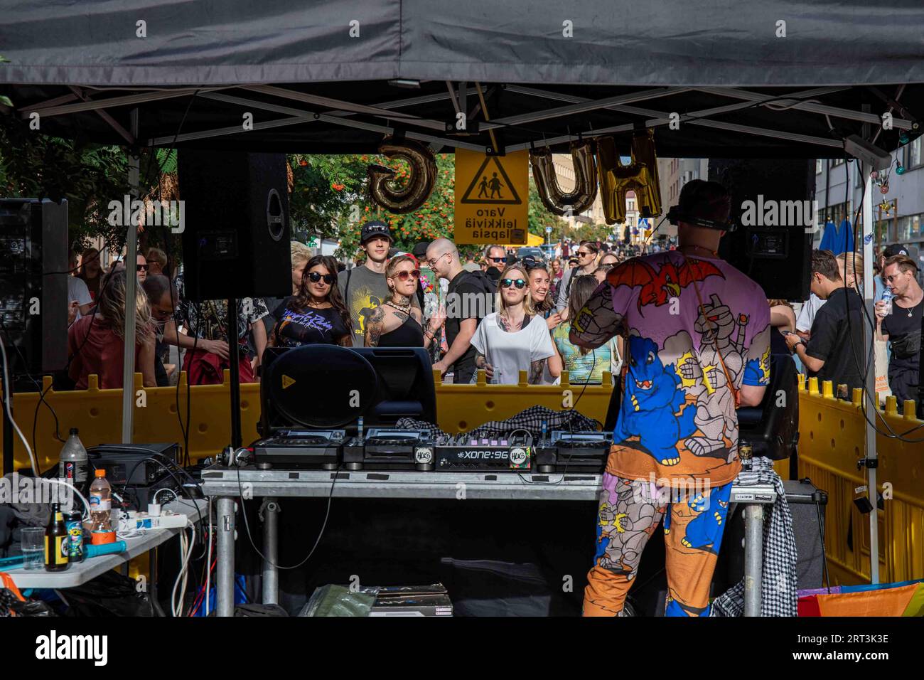 Young people dancing in front of an outdoor DJ booth at Kallio Block ...