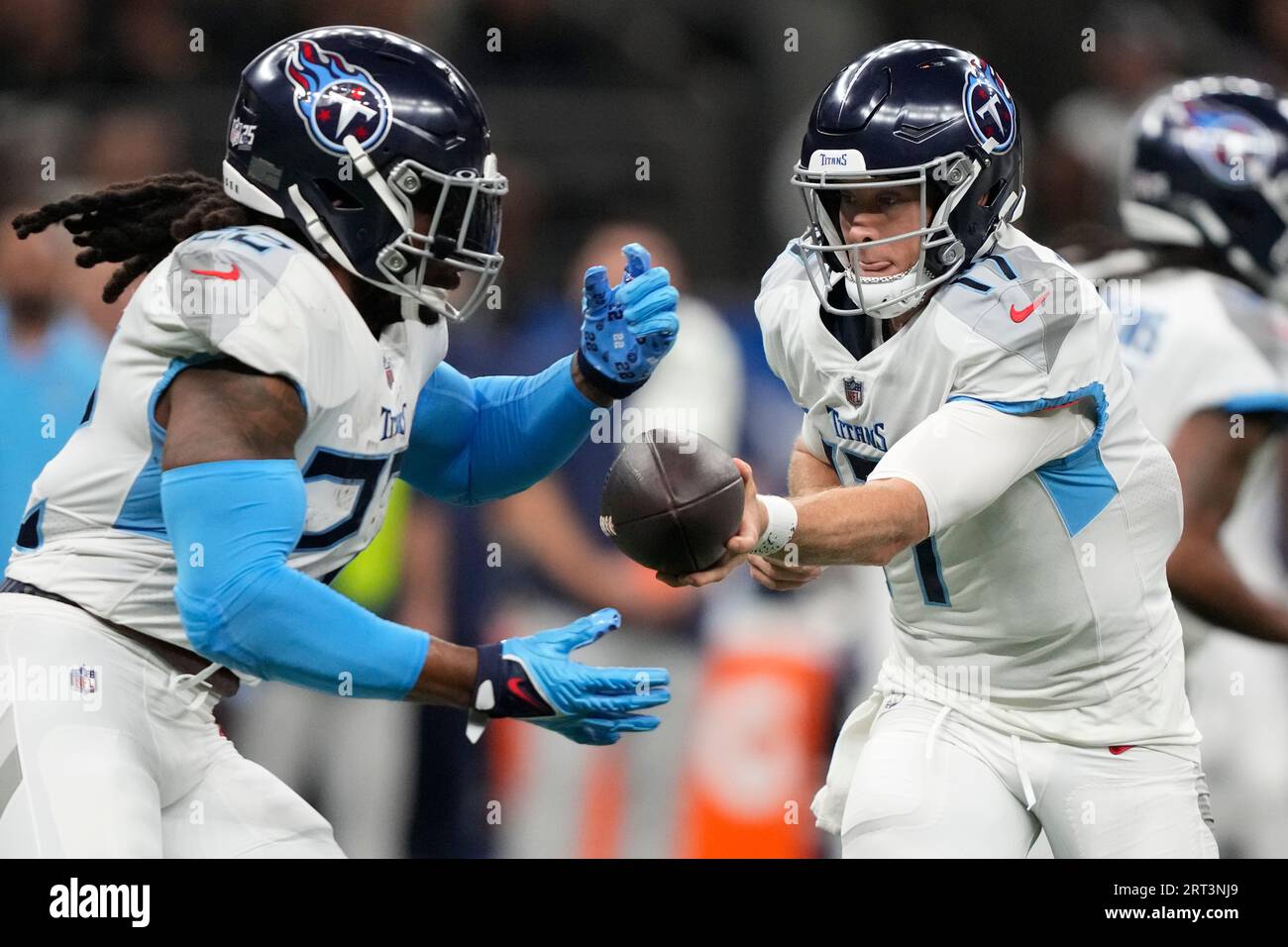 Tennessee Titans quarterback Ryan Tannehill, right, hands off to ...