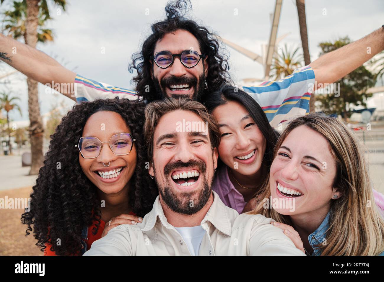 Happy and positive young adult friends having fun taking a selfie with ...