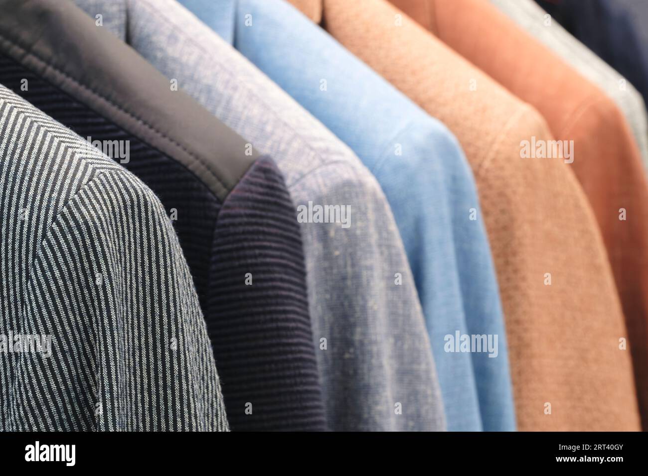Men's clothes suits hanging in closet hi-res stock photography and ...