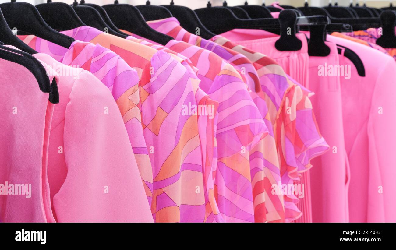 Fashion clothes on clothing rack Closeup of rainbow color choice female ...