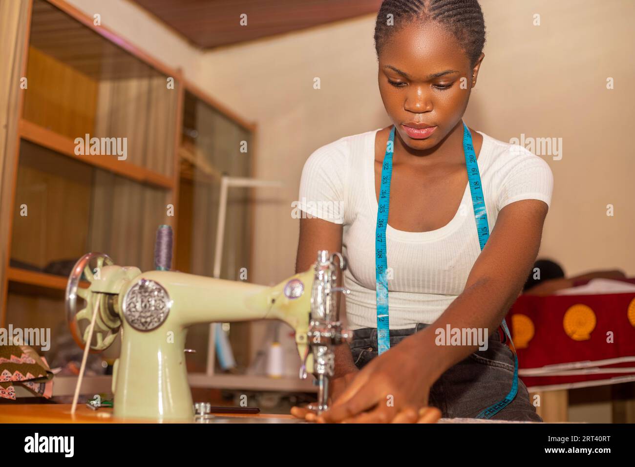 female african tailor sewing with her machine Stock Photo - Alamy