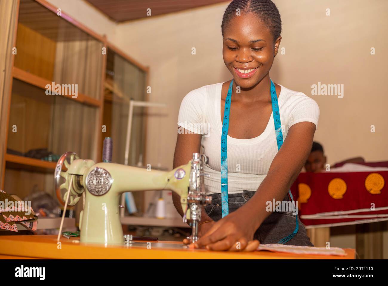 african seamstress sews clothes. Workplace of tailor - sewing machine ...