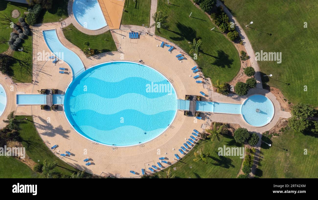 The original round swimming pool with sun loungers in the garden ...