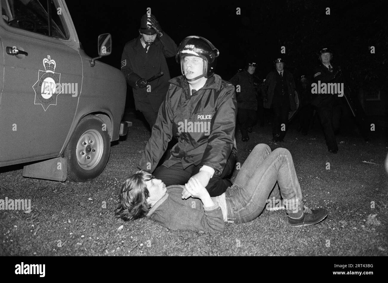 Toxteth Riots 1980s UK. A teen is arrested for rioting, being help by a ...