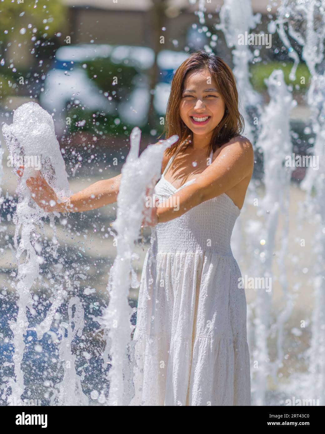 Beautiful Young Happy Asian Woman Playing in Outdoor Fountain on a ...