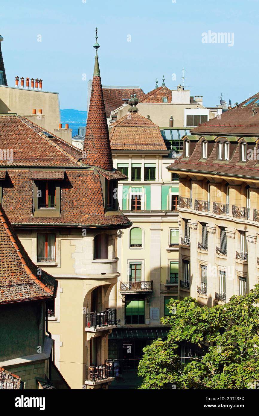 Vertical view of the roofs and windows of Geneva city against the blue ...