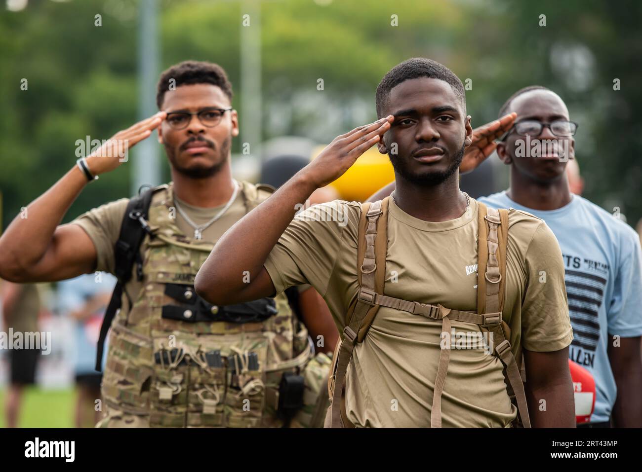 Soldiers saluting at event remembering military service members and ...