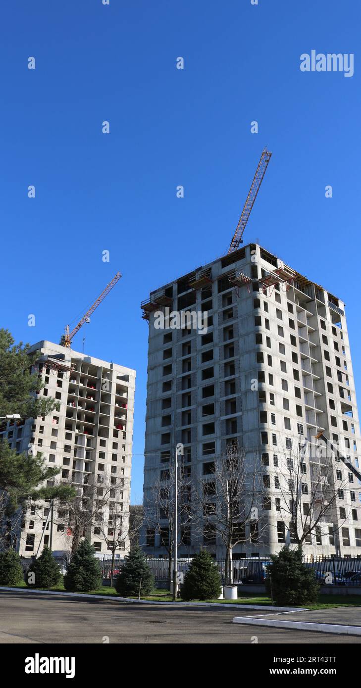 multi-apartment high buildings under construction with tower cranes ...