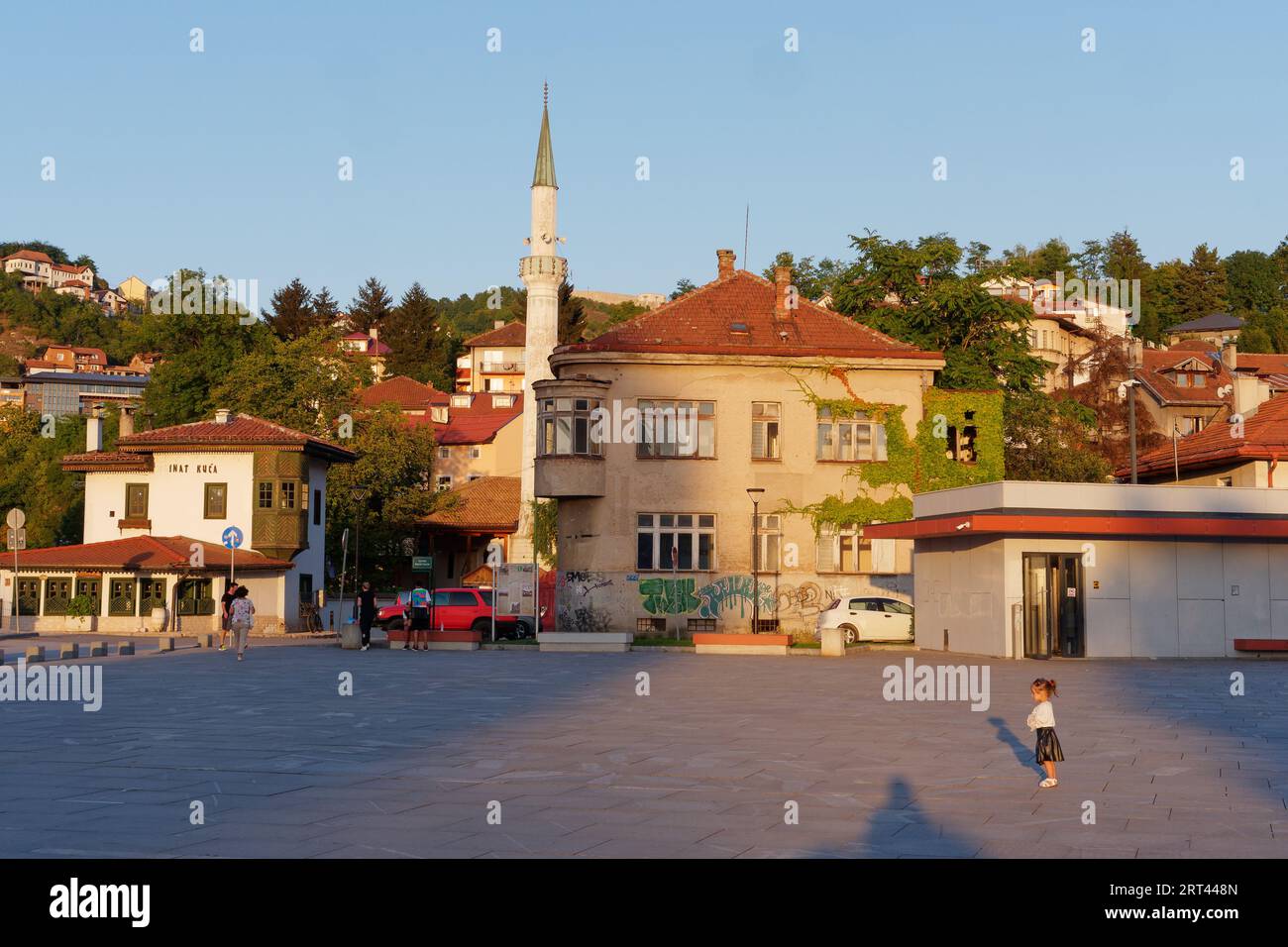 Square with Inat Kuca restaurant, minaret and mansion style property ...