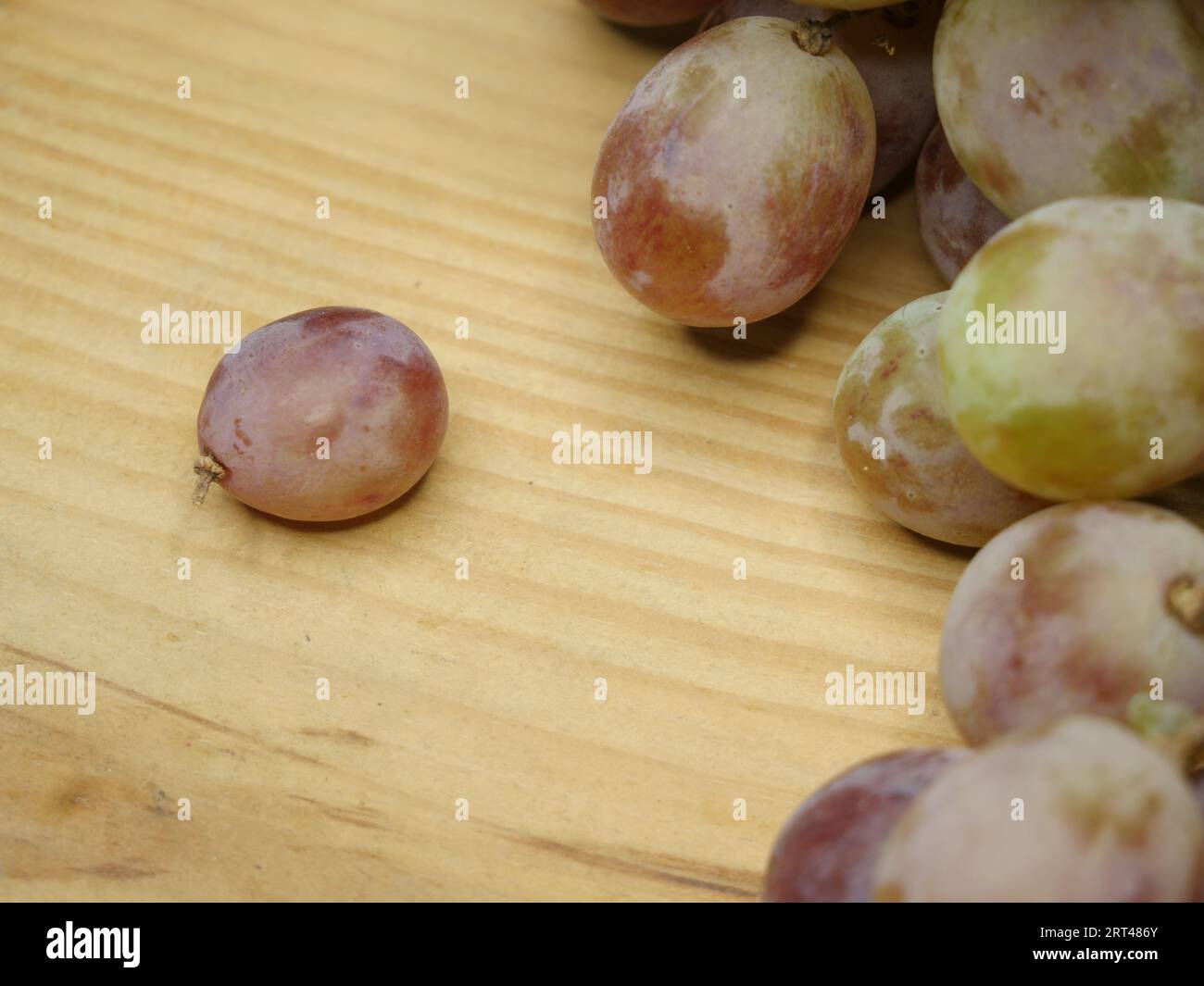 Grapes on table ,red globe grape variety Stock Photo - Alamy