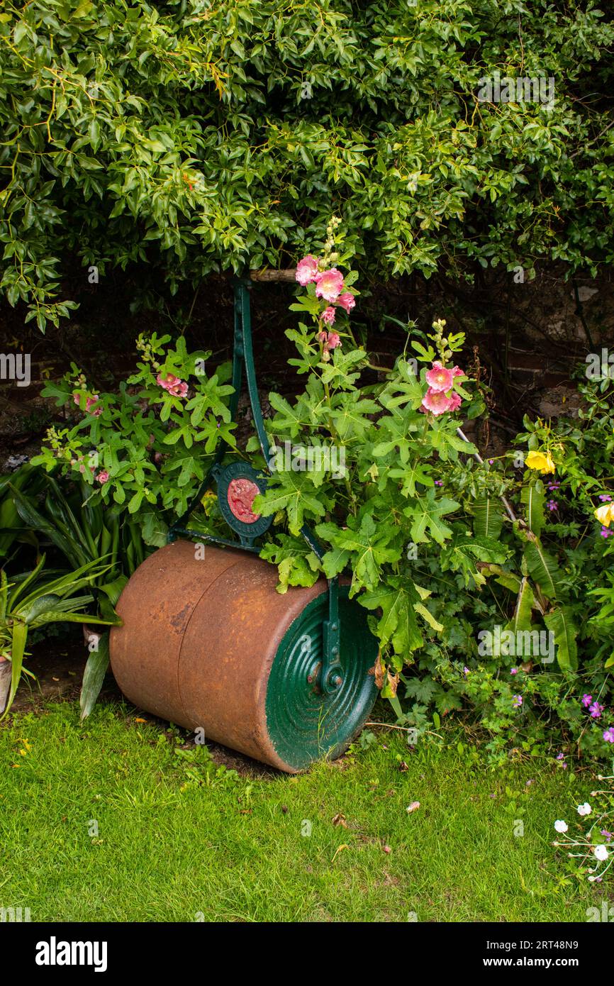 Garden Roller overgrown by plants Stock Photo - Alamy