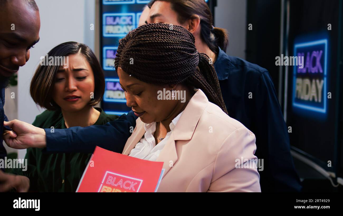 Mad diverse people at store entrance going crazy for black friday deals and promotions. African ...