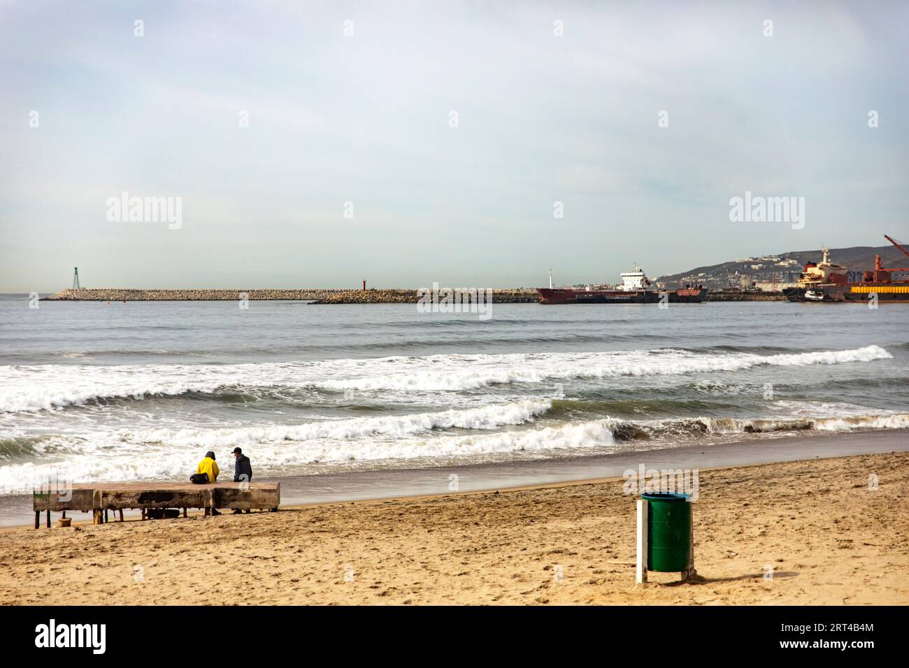 A beautiful beach in Ensenada with the port in the background and ...