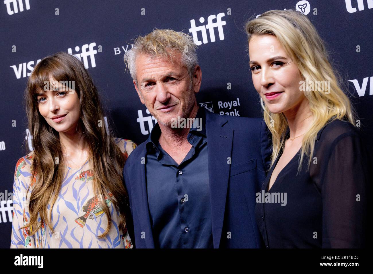 Dakota Johnson, from left to right, Sean Penn and Christy Hall attend ...