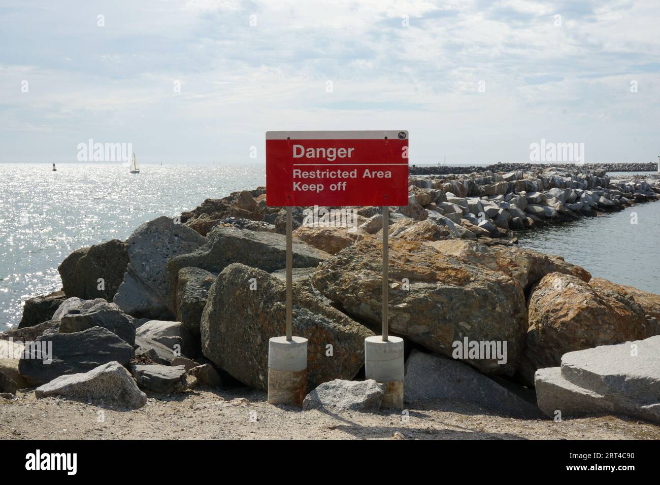 Warning sign rock jetty hi-res stock photography and images - Alamy