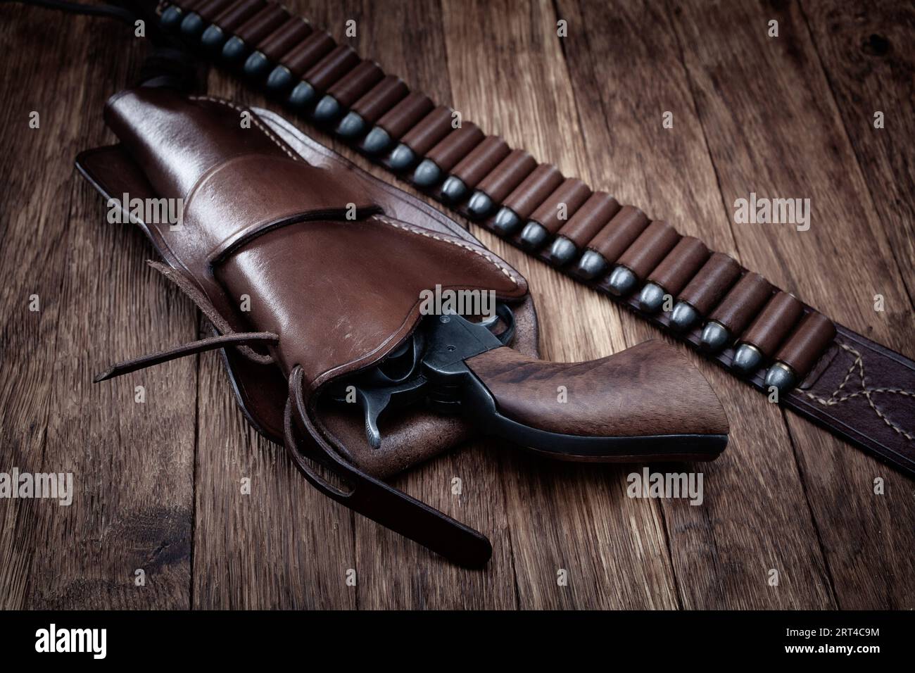 Old west leather gun belt with ammnunitions and revolver in holster on ...