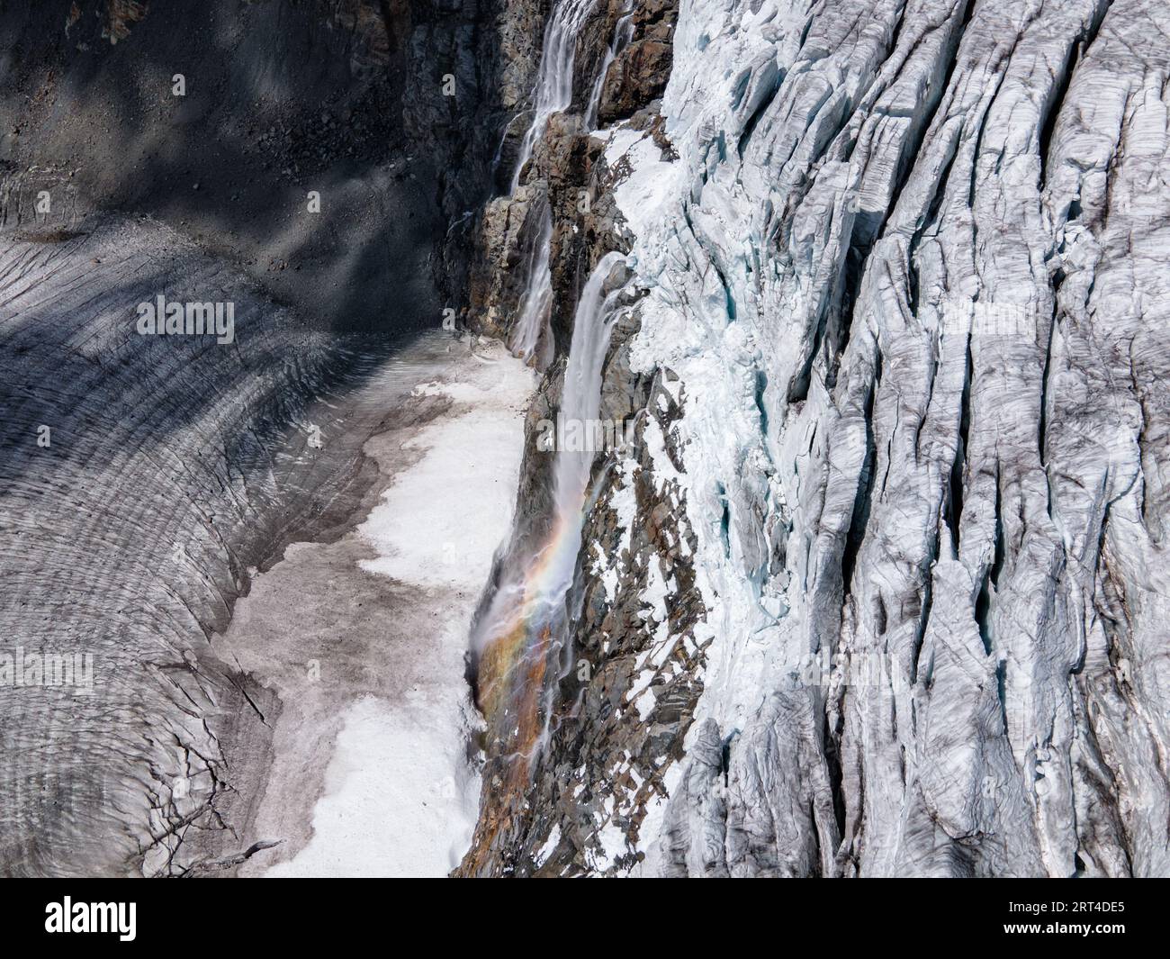 Aerial of melting glacier in the mountain, waterfall, lake, ice ...