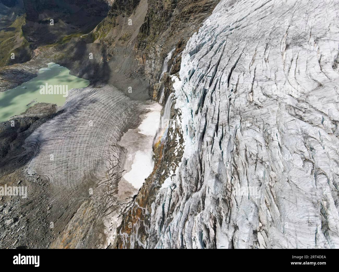 Aerial of melting glacier in the mountain, waterfall, lake, ice ...