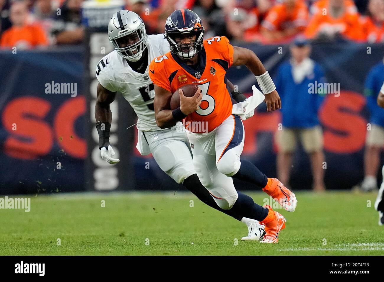 Denver Broncos quarterback Russell Wilson (3) runs the ball under ...