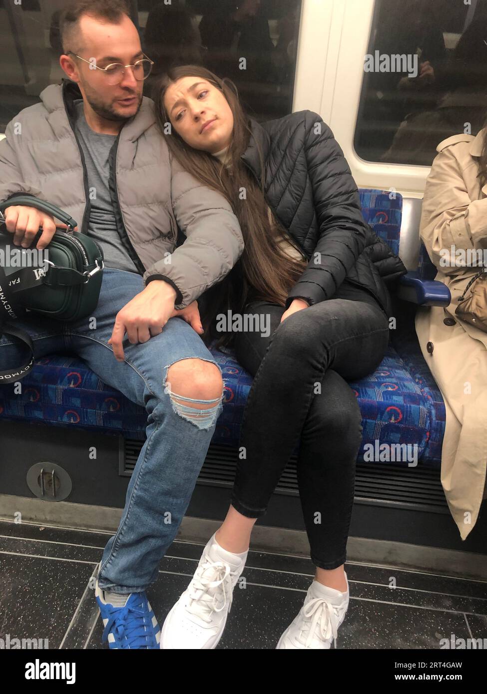England, London, Young couple travelling on the Victoria Line Tube ...