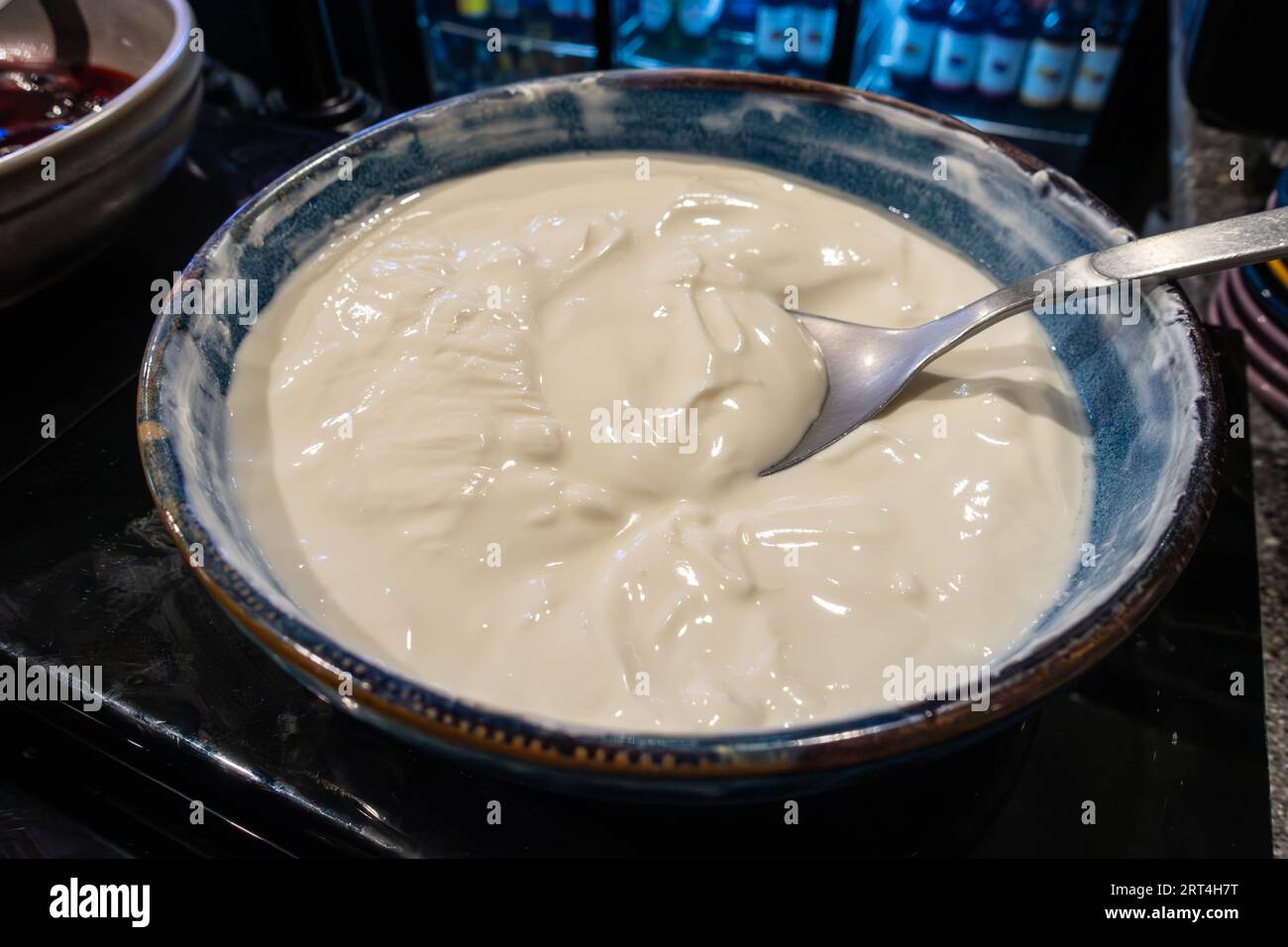 A bowl of fresh yoghurt at a self service breakfast buffet in a hotel ...