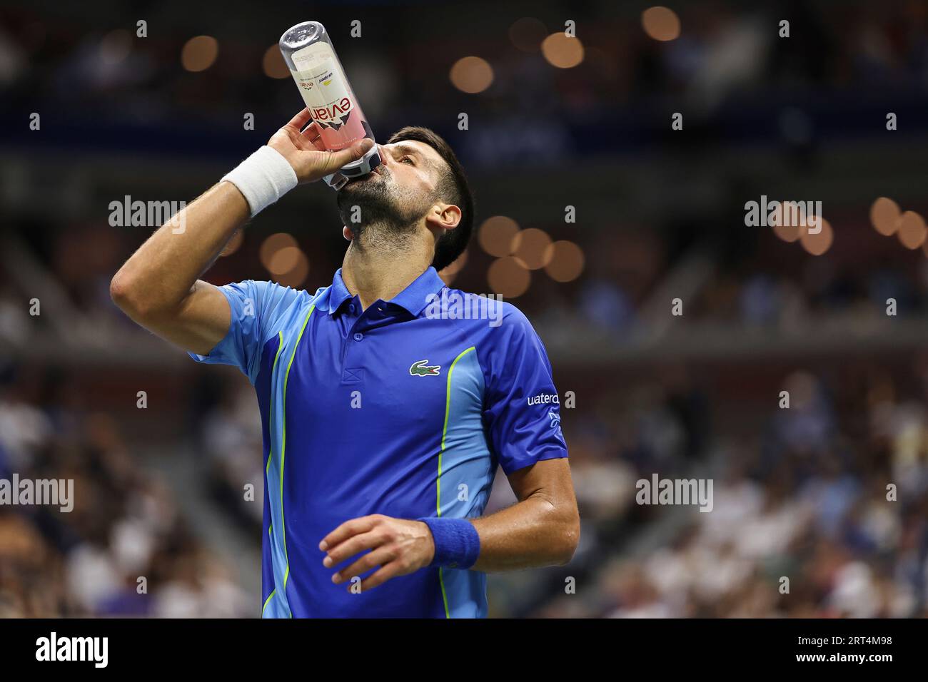Novak Djokovic drinks water during a men's singles championship match ...
