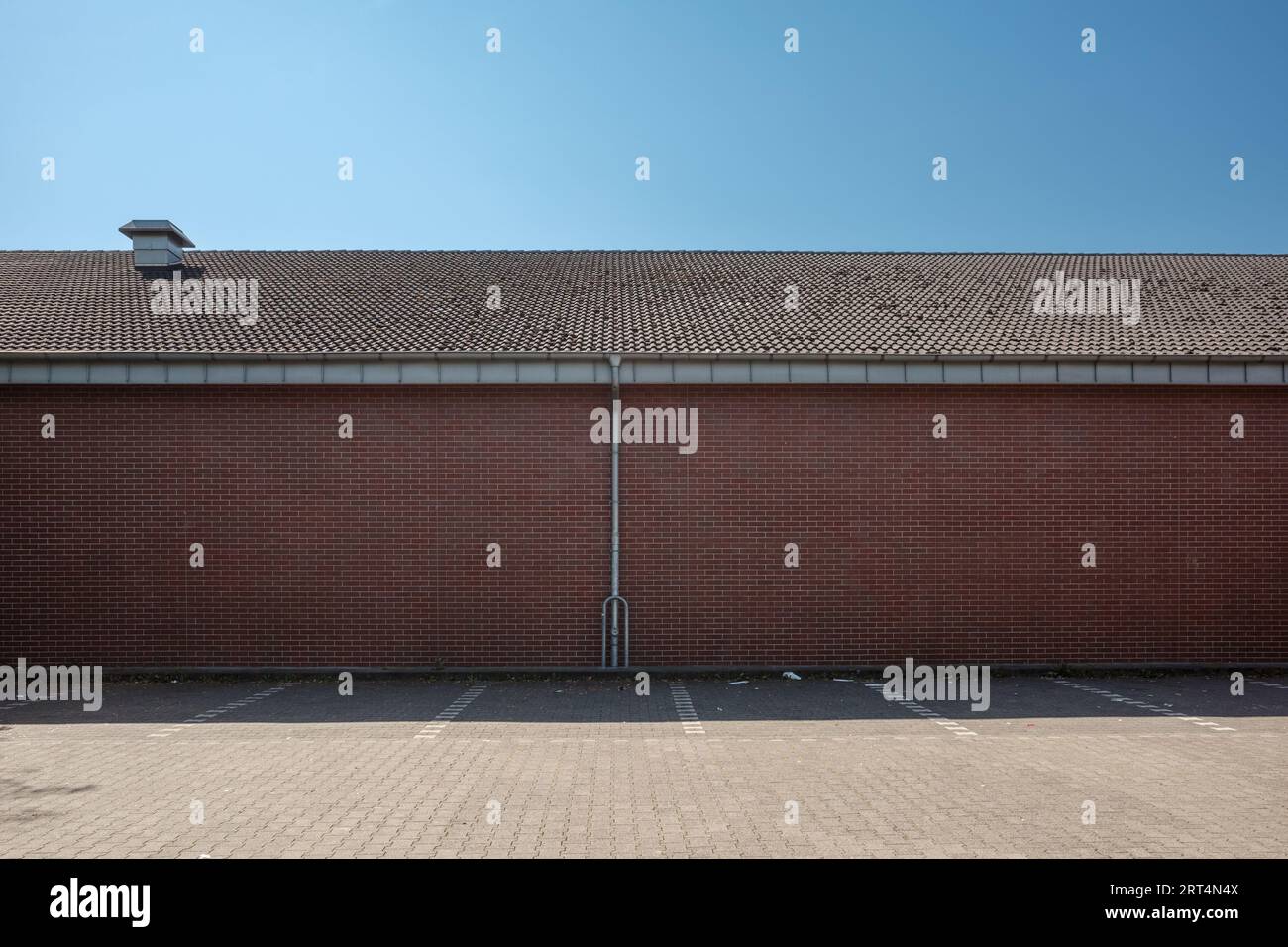Outdoor exterior view of empty parking lot and background of brick wall ...