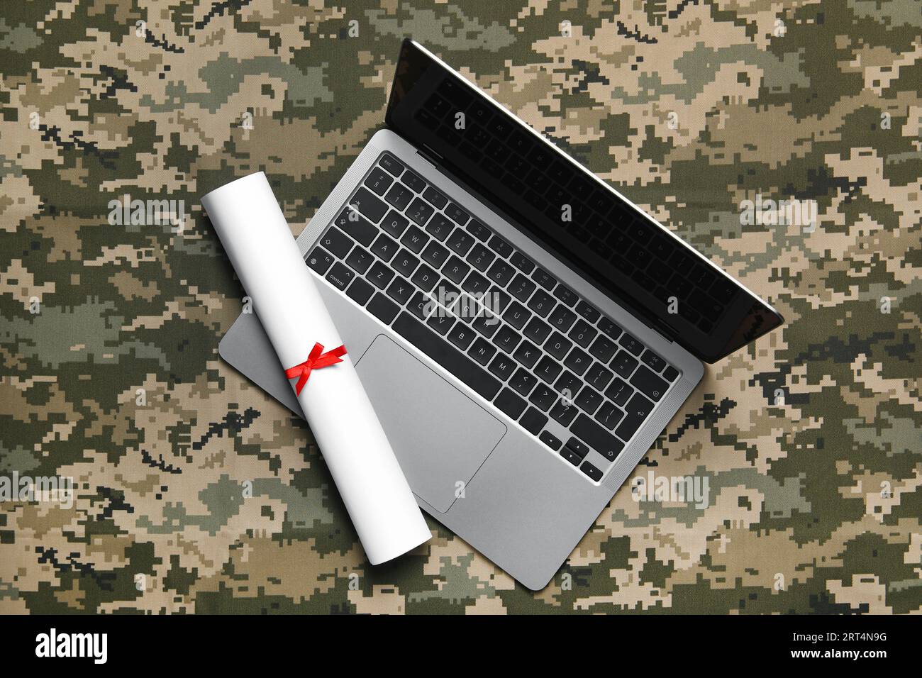 Laptop and diploma on camouflage background, top view. Military ...