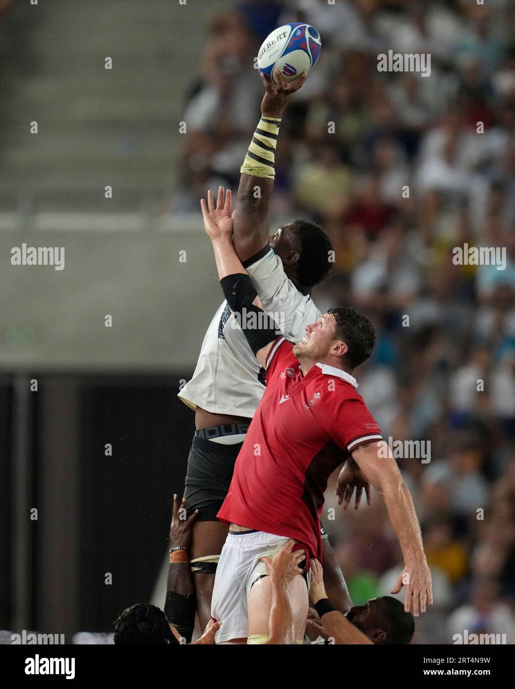 Fiji's Viliame Mata, top, catches ball as he wins the line-out throw ...