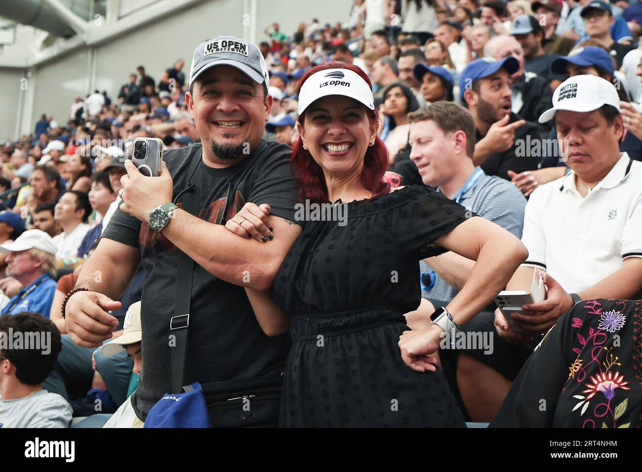 Tennis fans pose for a photo during a men's singles championship match ...