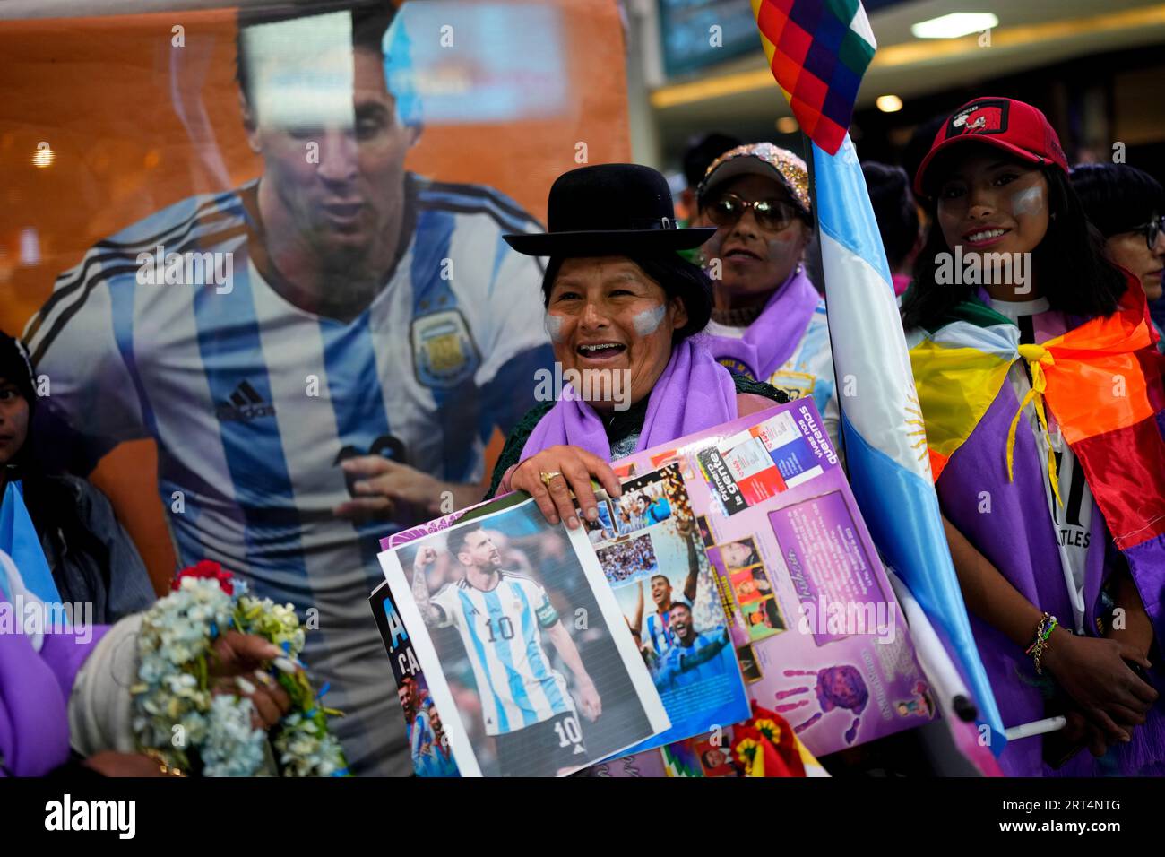 A woman holds a picture of Argentina's soccer star Lionel Messi as she ...