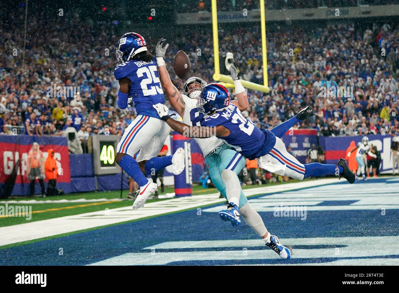 New York Giants' Deonte Banks, left, and Xavier McKinney, right, break ...