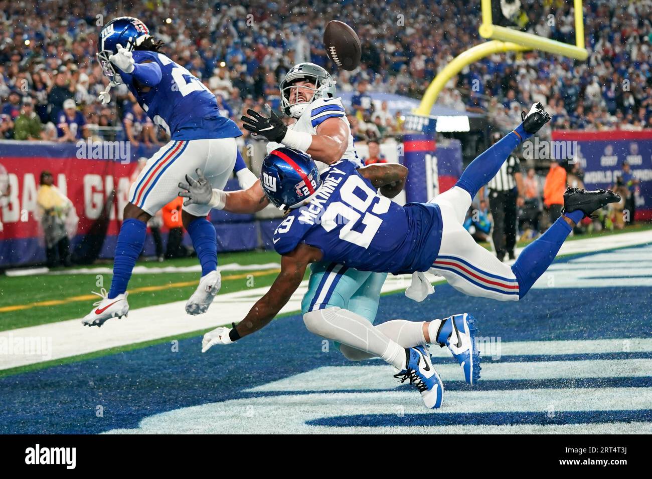New York Giants' Deonte Banks, left, and Xavier McKinney, bottom right ...